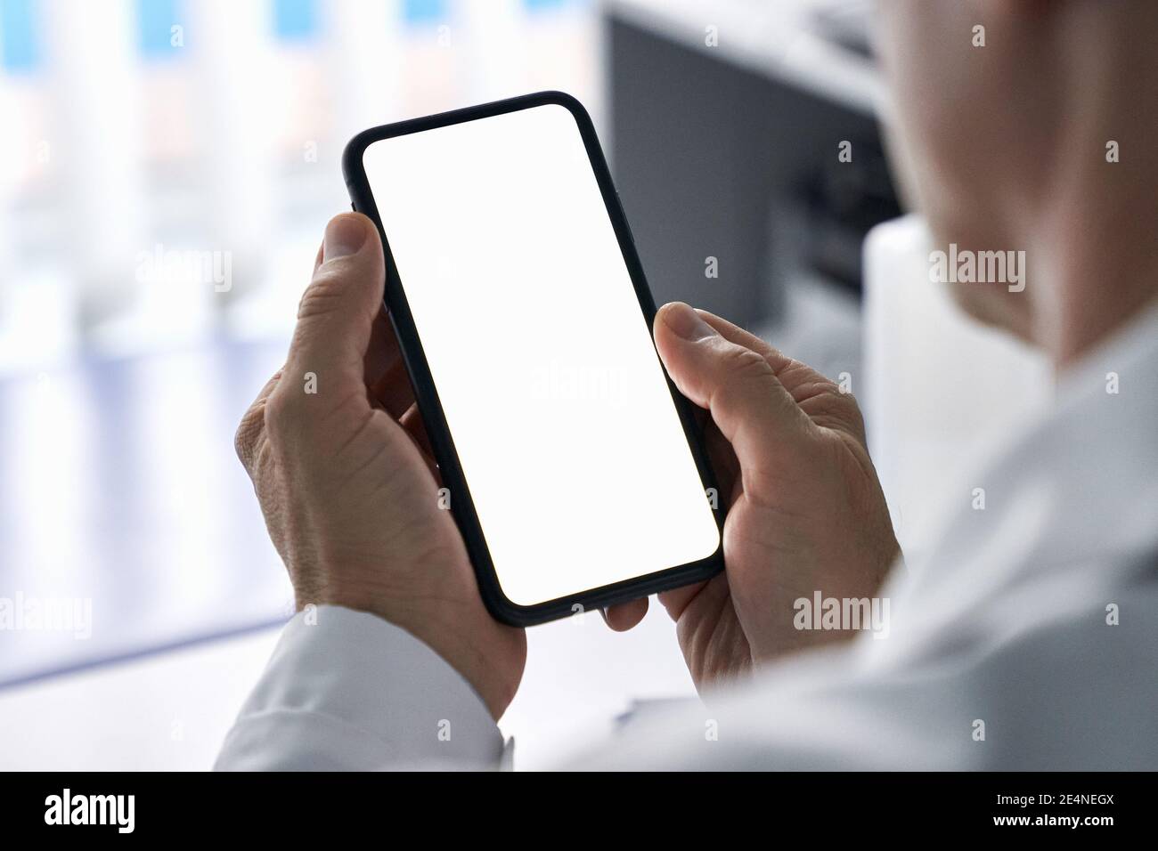 Male doctor holding cell phone using white screen ehealth mobile app ...