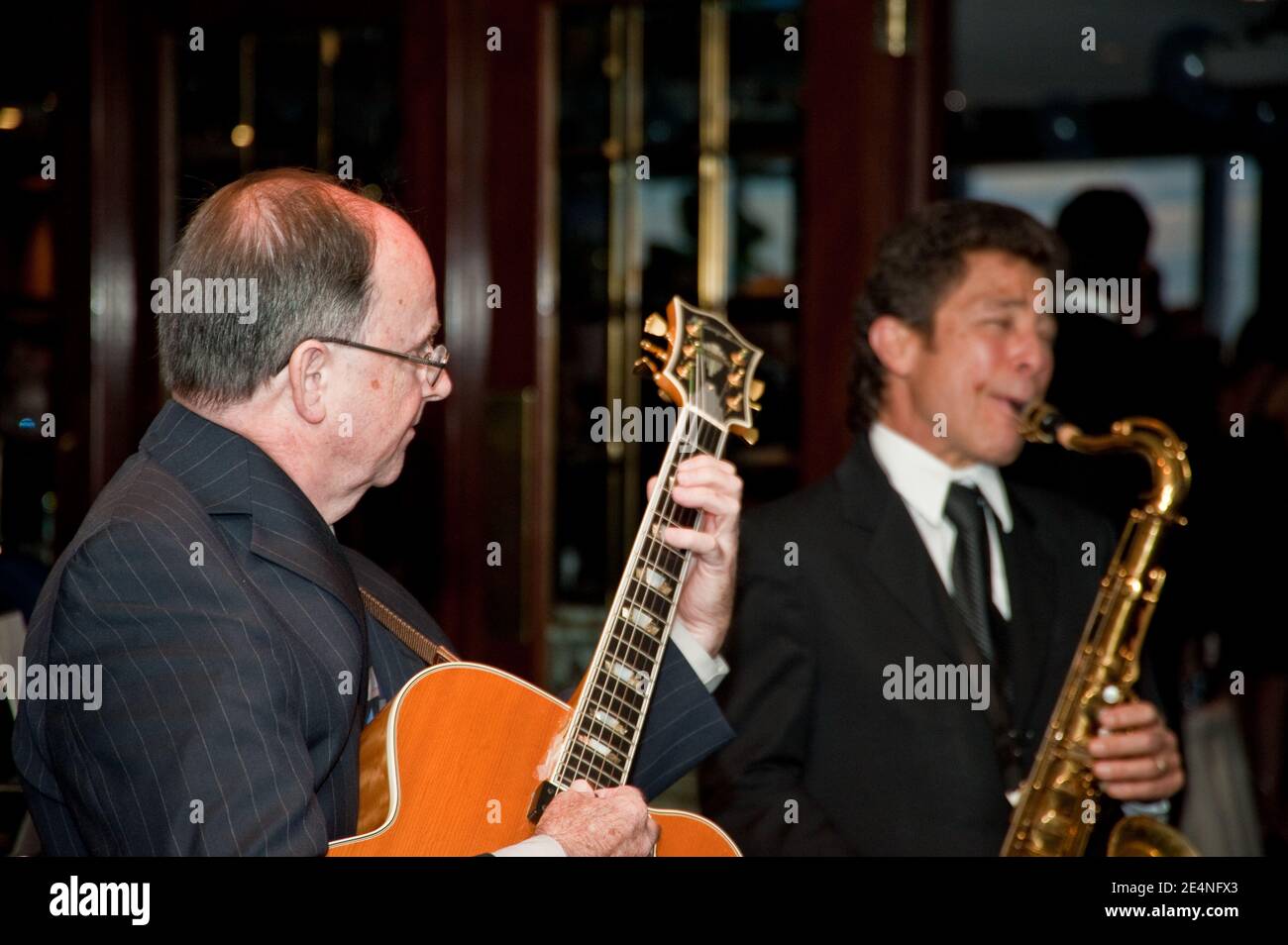 Duets of Saxophone and Guitar by Two Male Musicians at a Party Stock ...