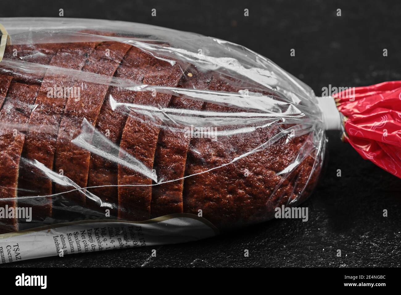 Sliced black rye bread in plastic bag on dark background Stock Photo ...