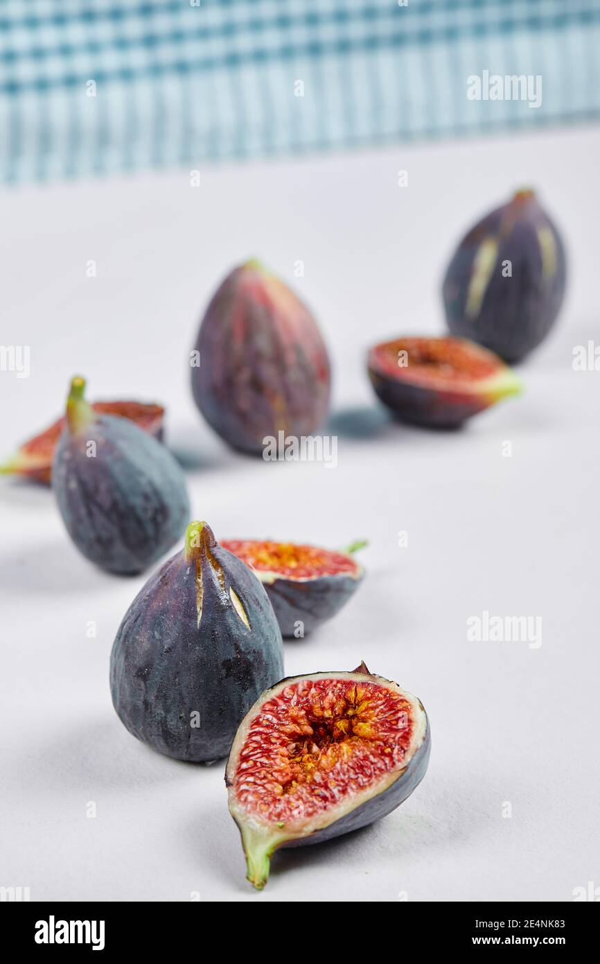 Whole fig and fig slices on a white background Stock Photo - Alamy