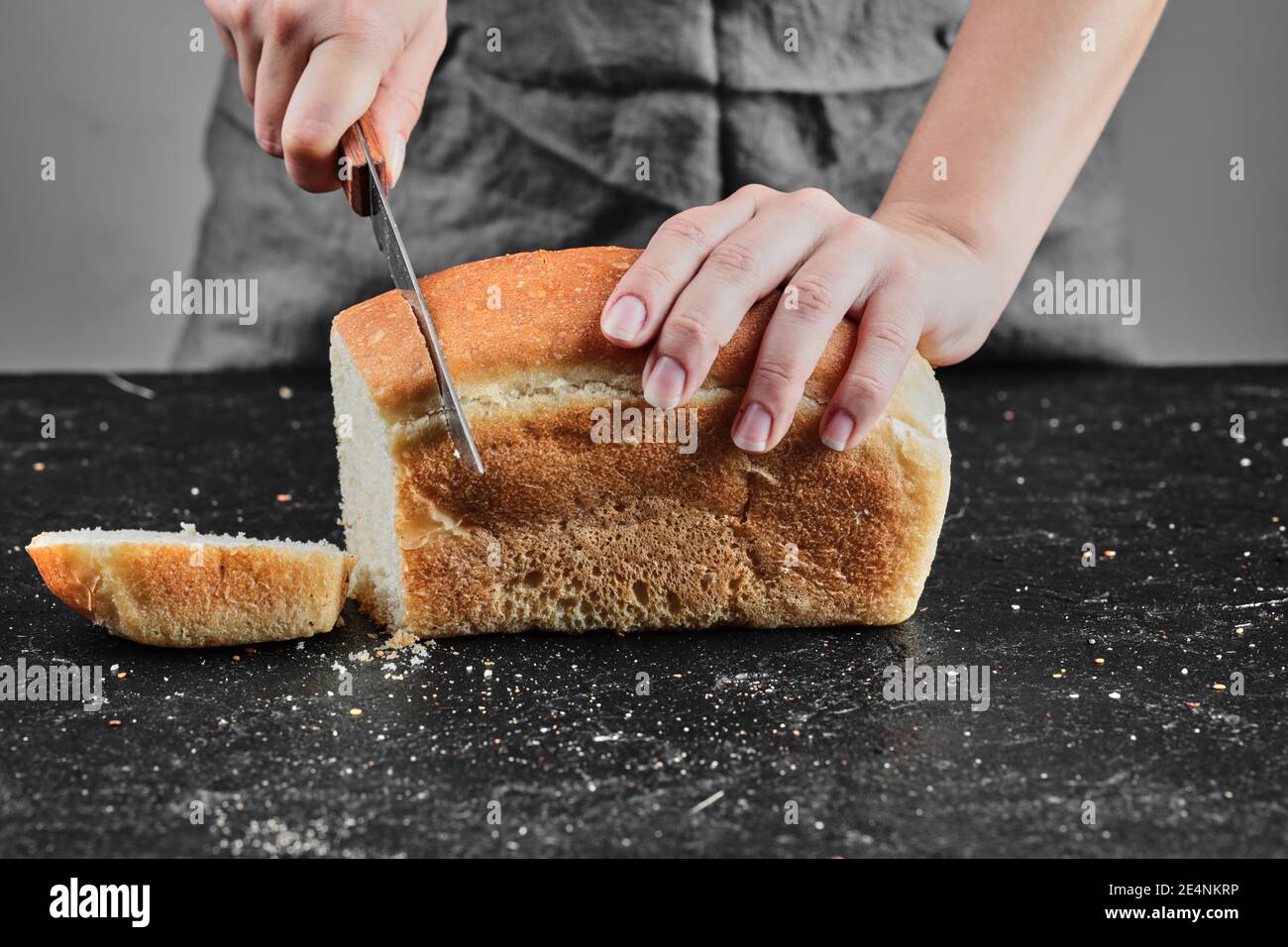 Hands woman cutting bread loaf hi-res stock photography and images - Alamy