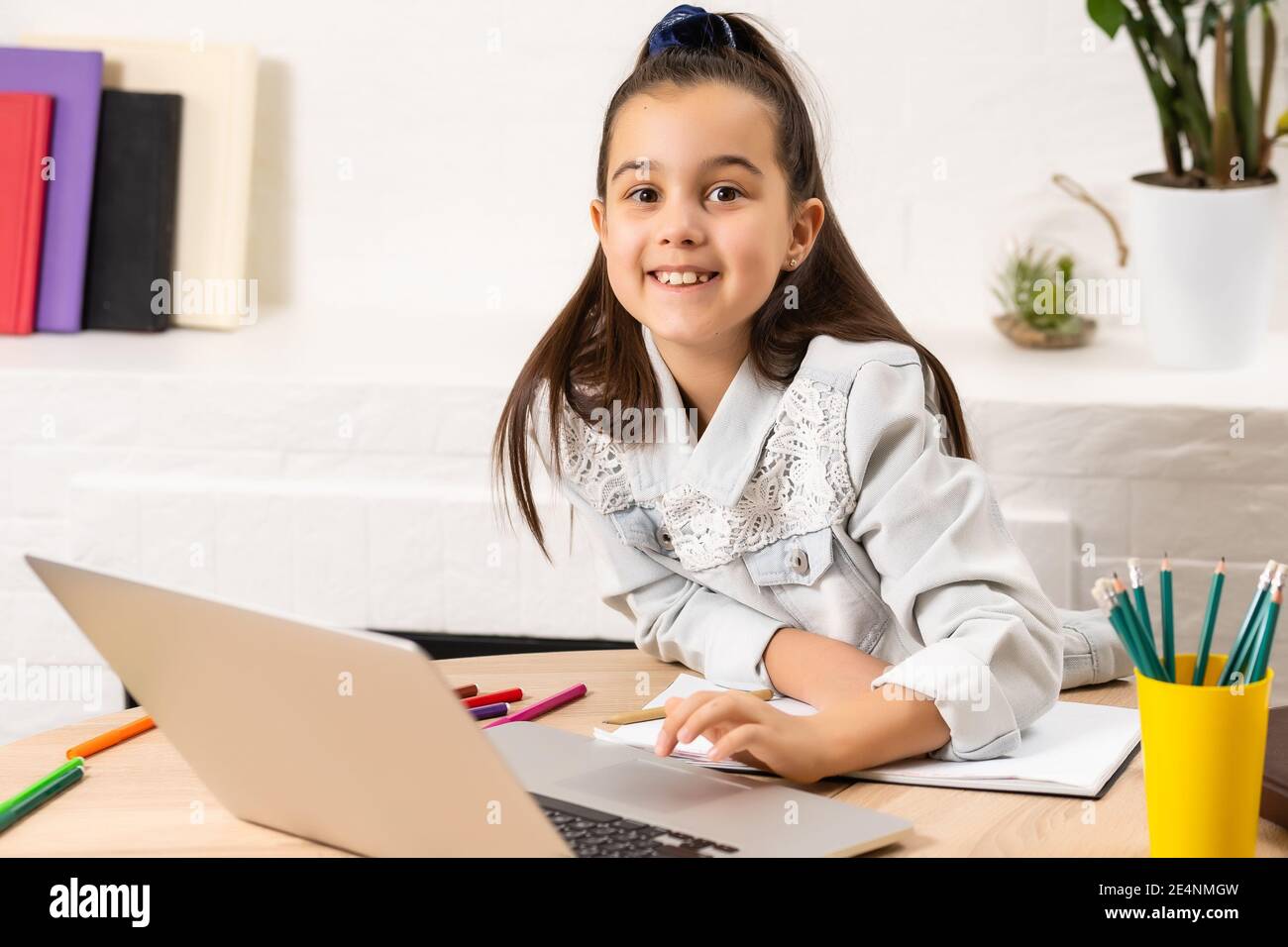Student little school girl homework on laptop computer silver Stock ...