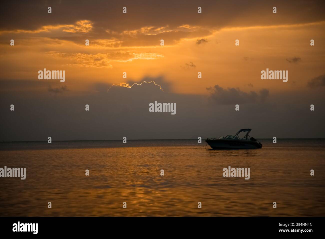beautiful sunset at sea. speed boat in the rays of the evening sun ...