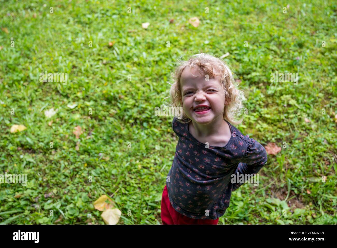 Drop down portrait of cute girl making faces Stock Photo - Alamy