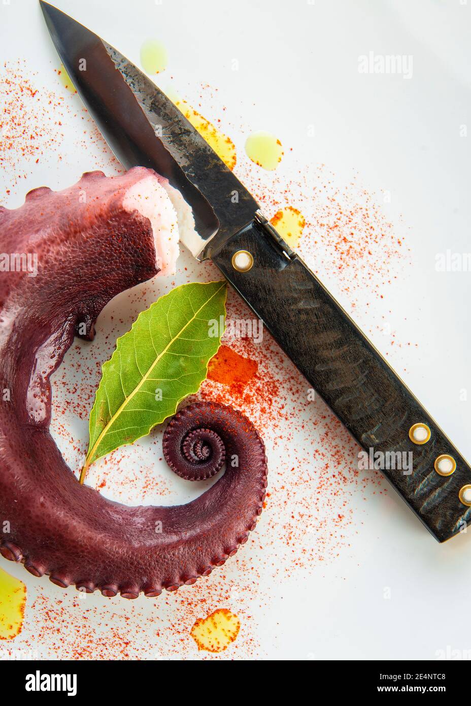 Cooked octopus tentalce isolated on a white background and decorated ...