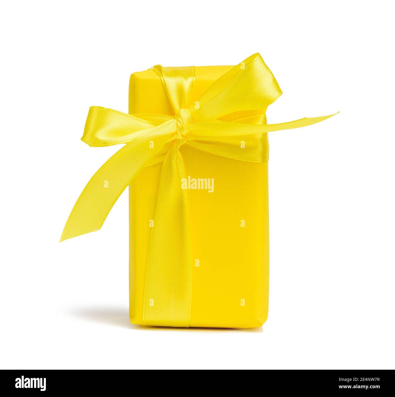 rectangular box with a gift wrapped in yellow paper and tied with a ...
