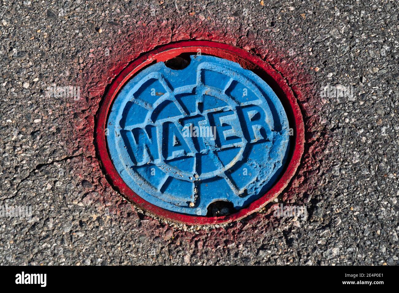 Red and blue water access point in the asphalt Stock Photo - Alamy