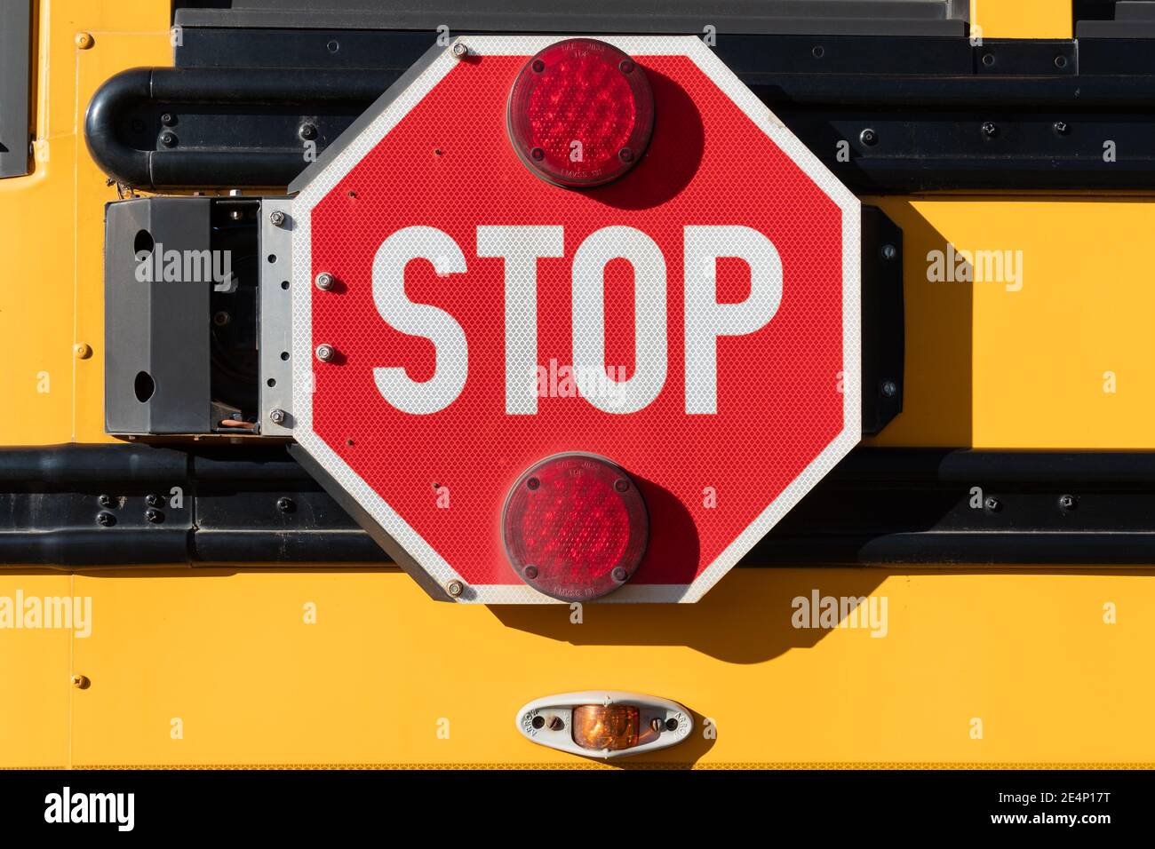 Stop sign on the side of a school bus Stock Photo - Alamy