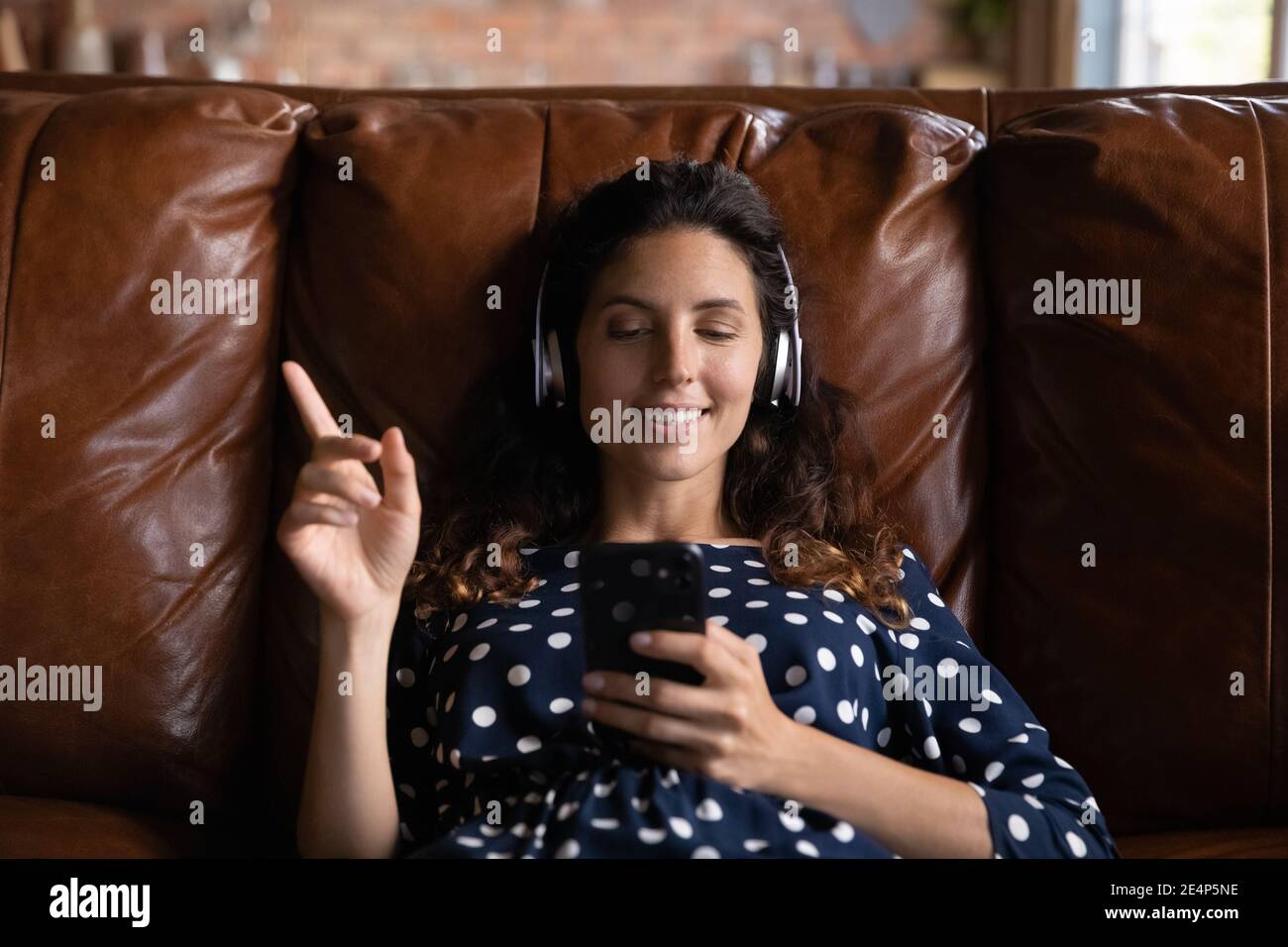 Happy woman relax at home listening to music Stock Photo - Alamy