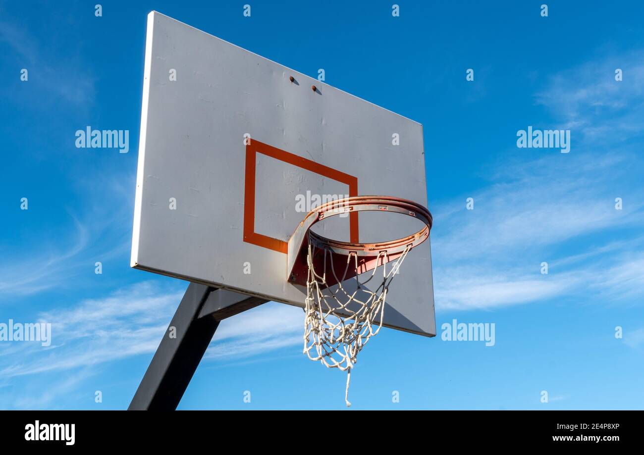 Playground basketball hoop with torn net Stock Photo - Alamy
