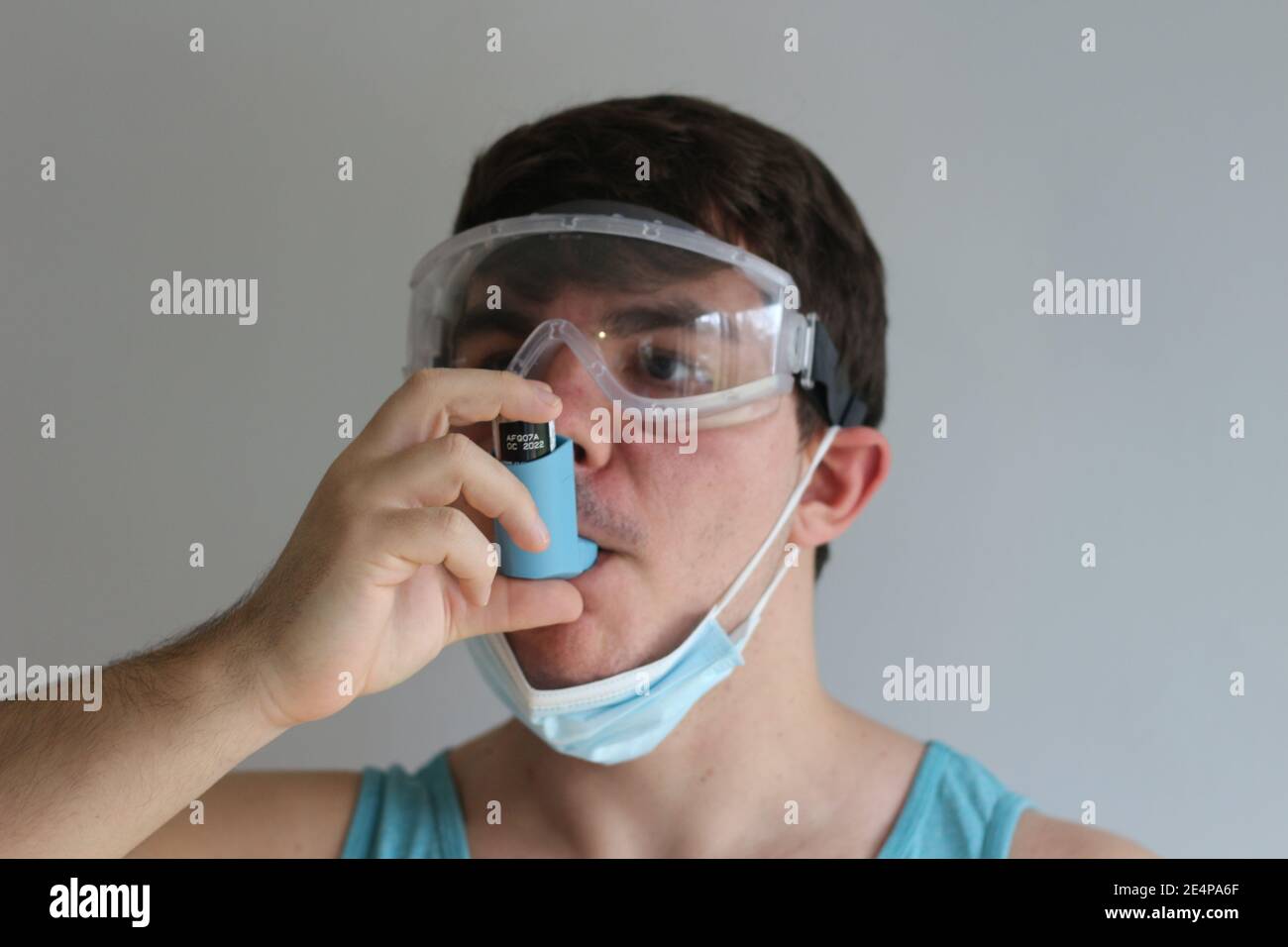 man in full ppe shows how to use a rescue inhaler Stock Photo - Alamy