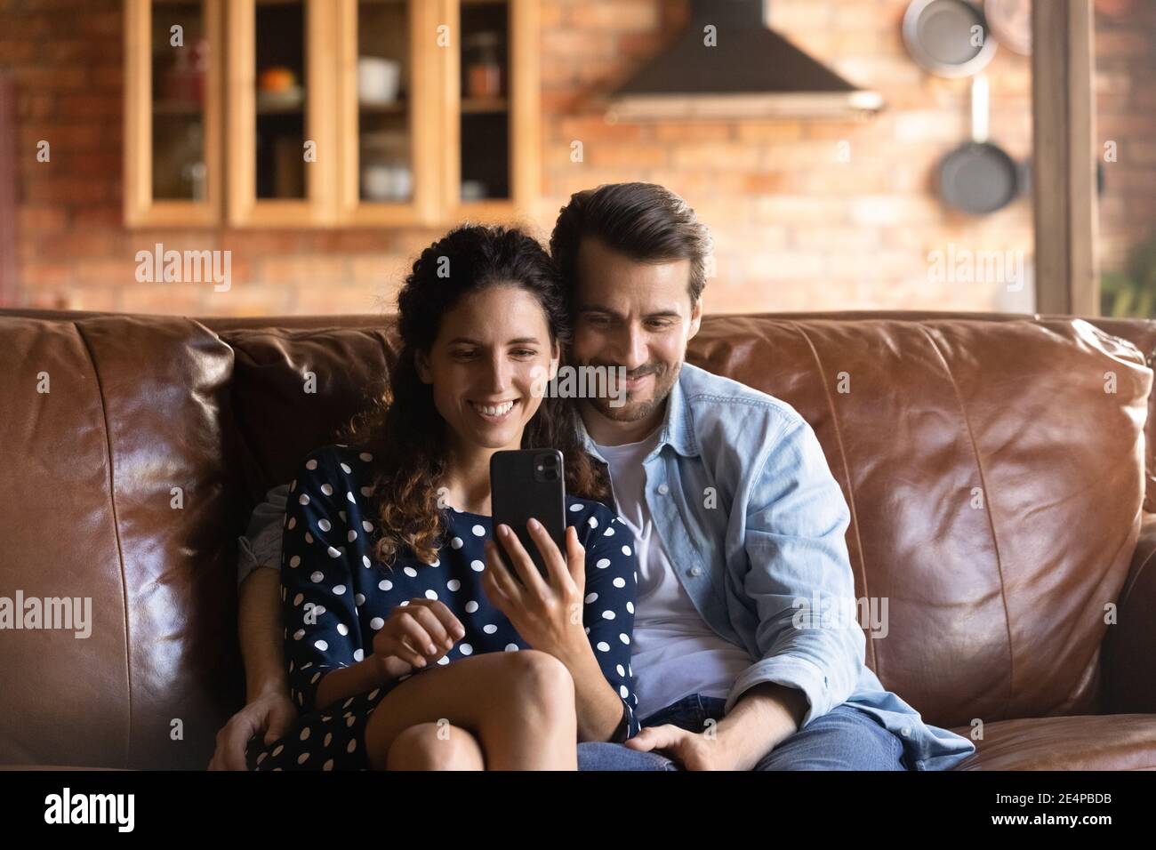 Happy couple use smartphone talking on video call Stock Photo - Alamy