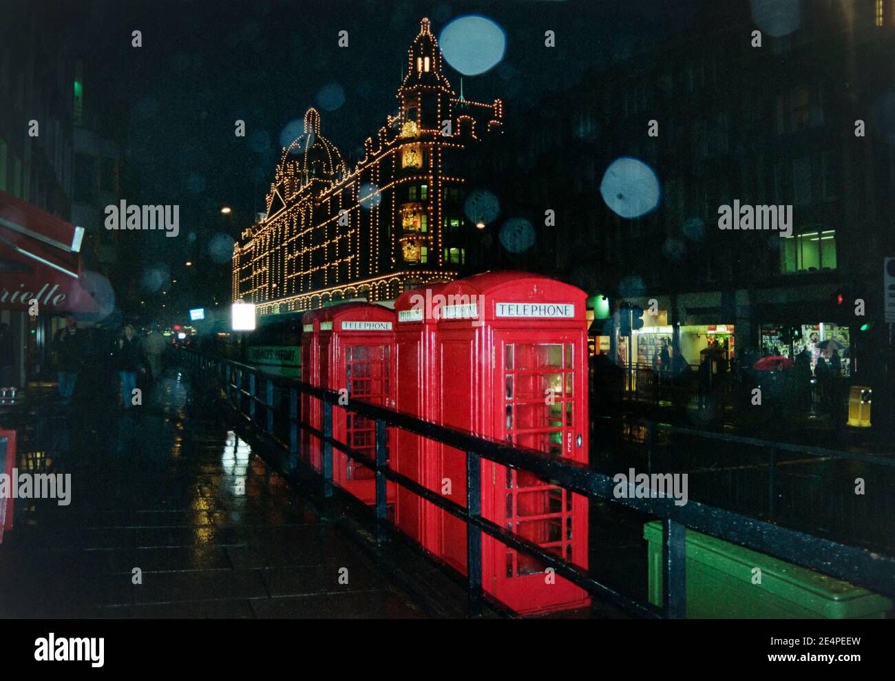 Red telephone booths in front of Harrods at rainy night Stock Photo - Alamy