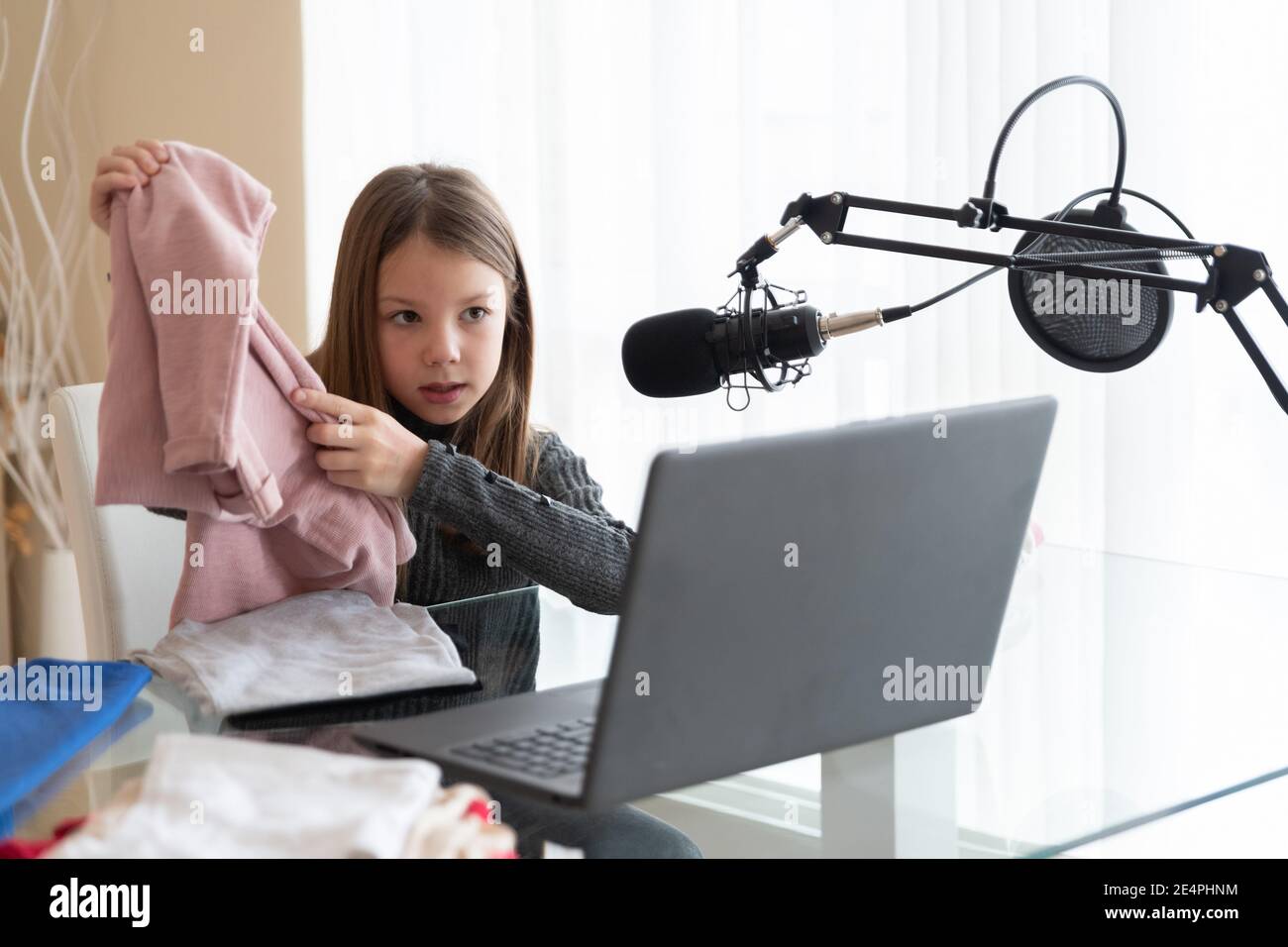 A cute vlogger shows her clothes online while sitting at home. It talks ...