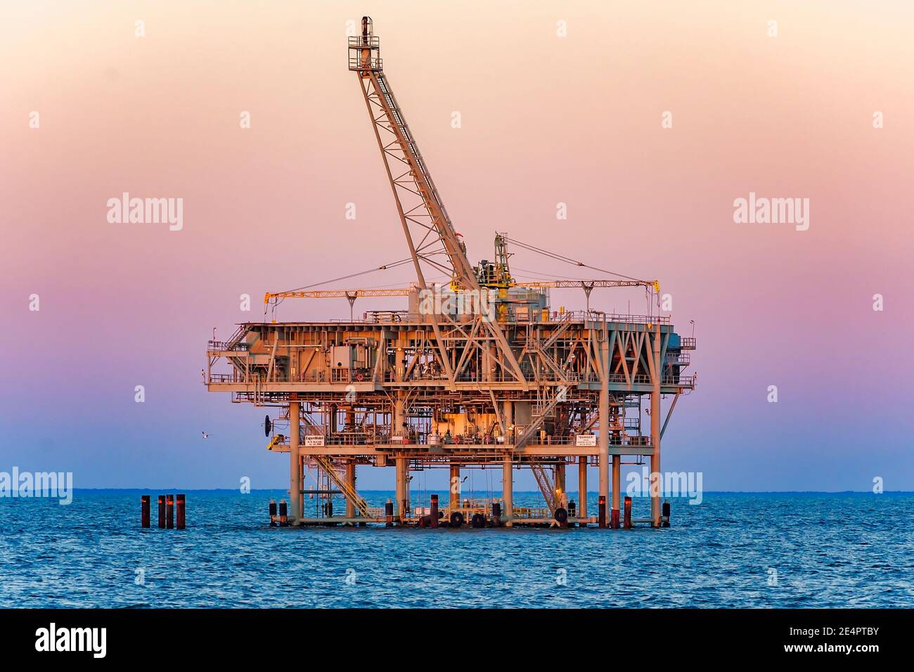The sun sets on an ExxonMobil natural gas rig in the Gulf of Mexico ...