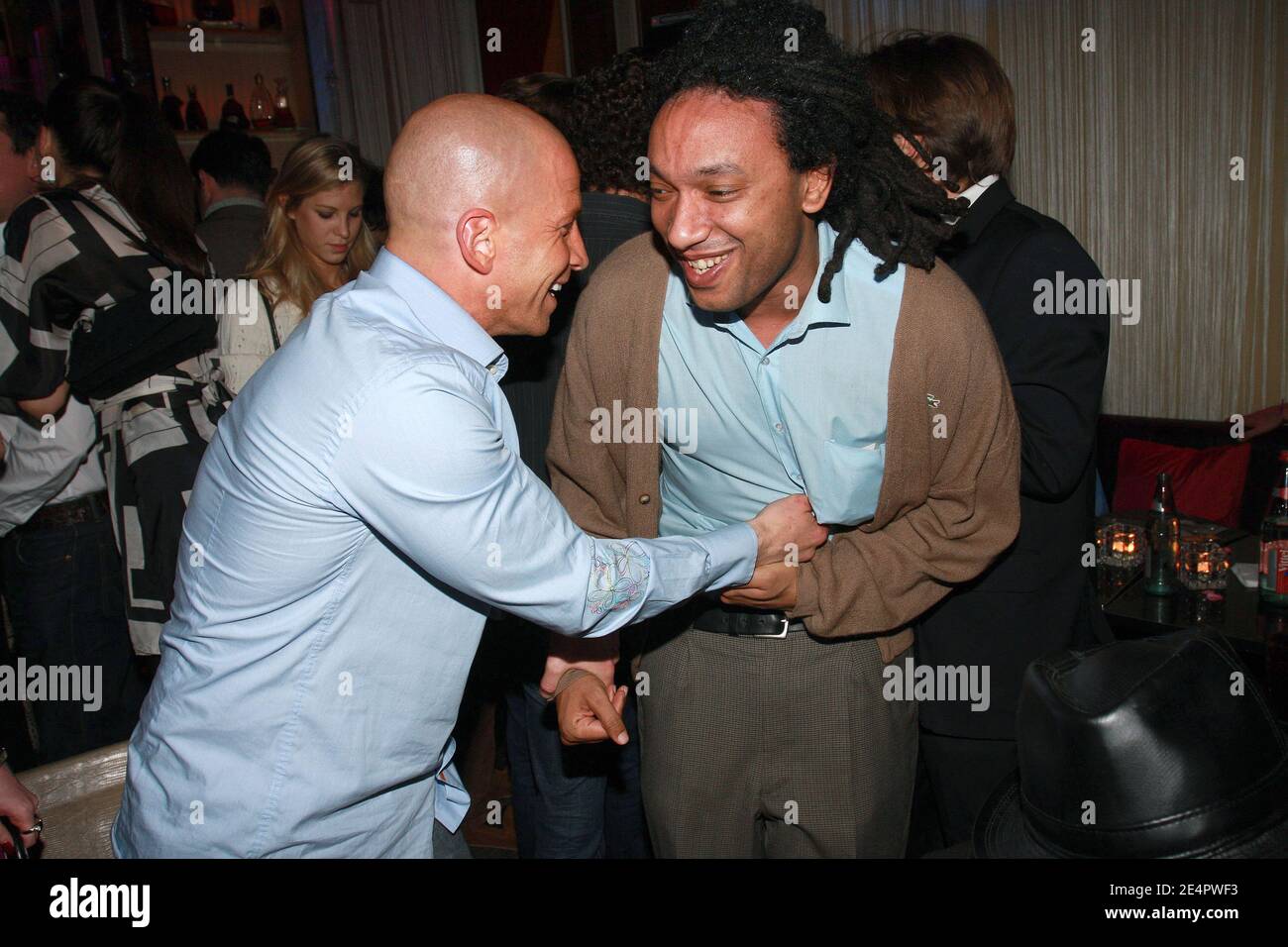 French kick boxing champion Dida Diafat (L) jokes with French singer ...