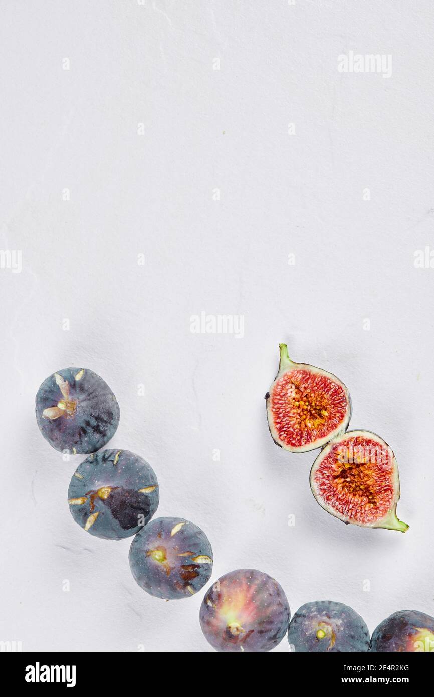 Whole fig and fig slices on a white background Stock Photo - Alamy