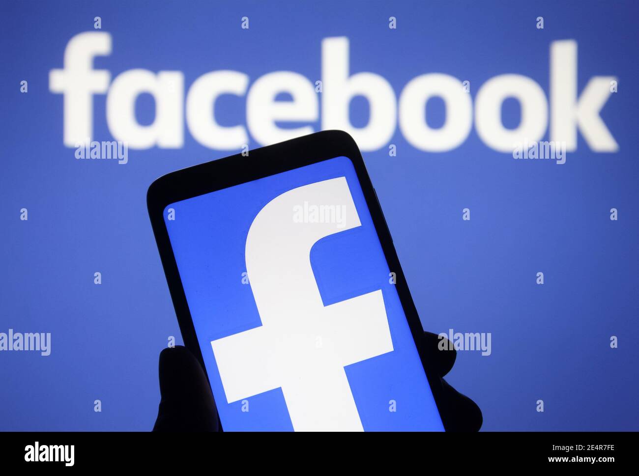 In this photo illustration the Facebook logo seen displayed on a mobile ...