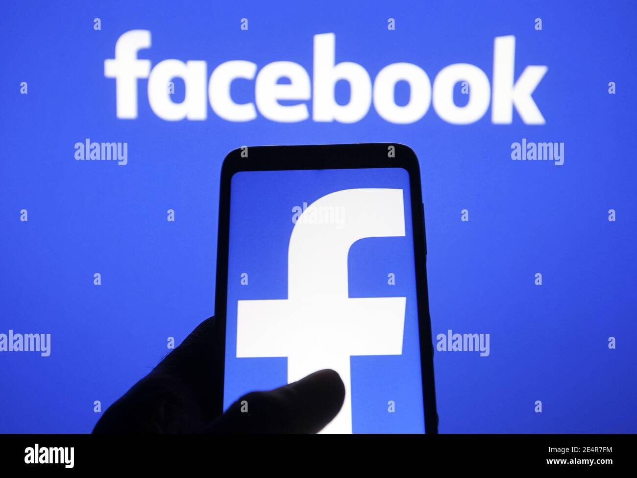 In this photo illustration the Facebook logo seen displayed on a mobile ...