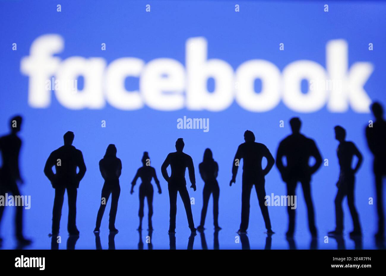 In this photo illustration silhouettes of toy people seen with the ...