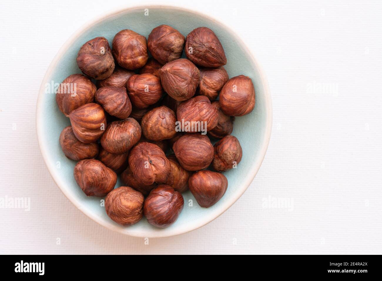 Whole Hazelnuts in a Bowl Stock Photo - Alamy