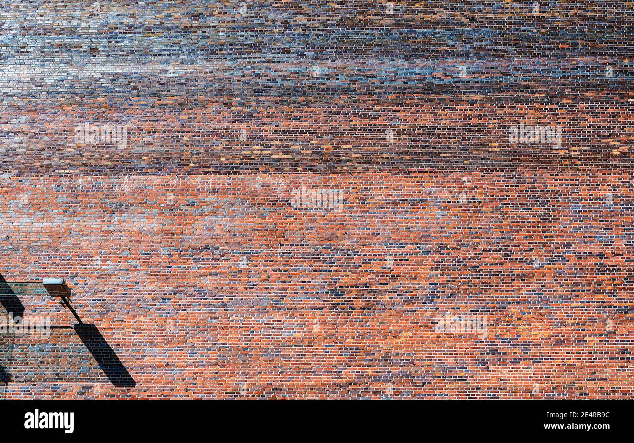 Large brick wall. A pattern composed of many small bricks of various ...