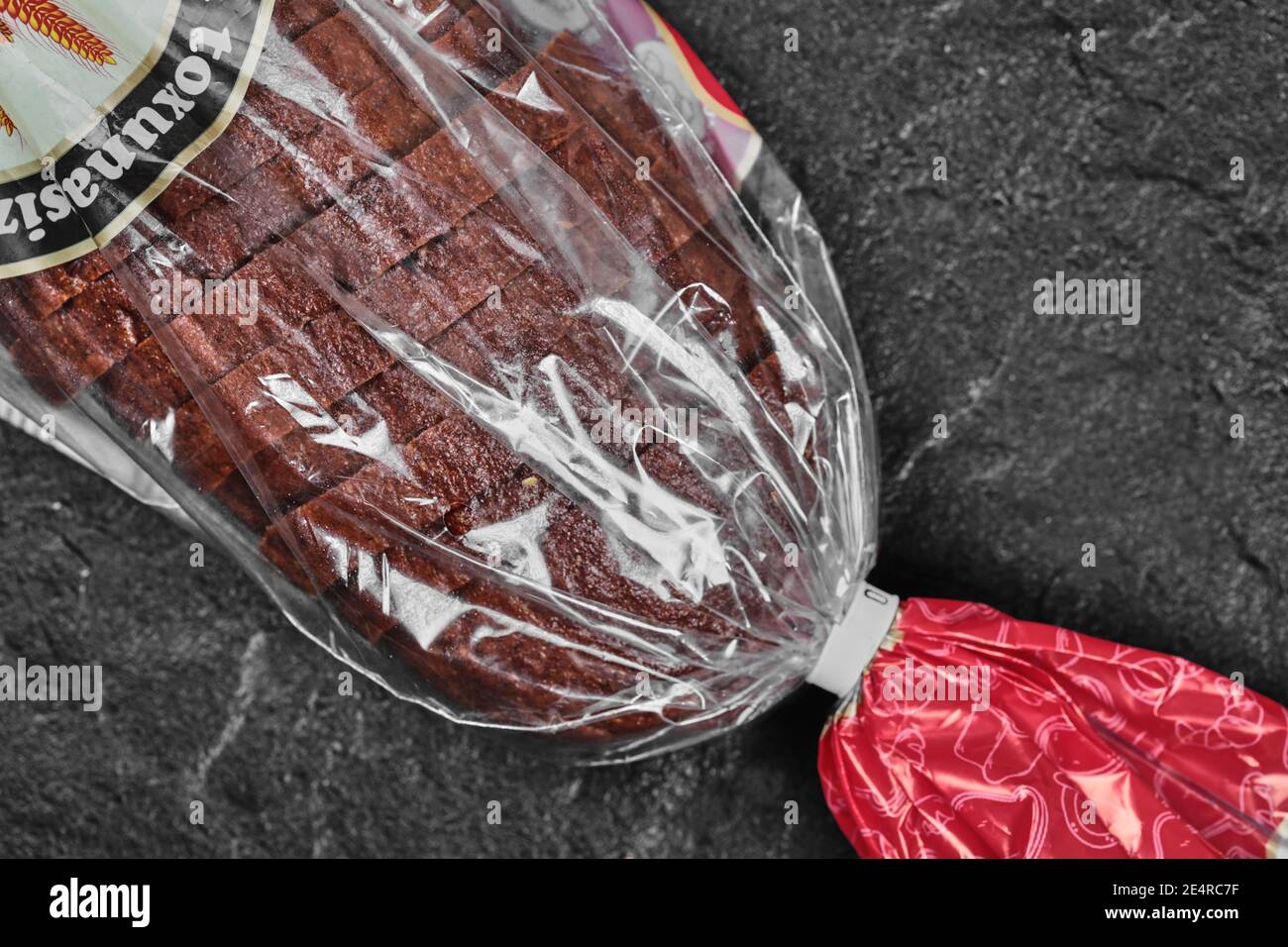 Sliced black rye bread in plastic bag on dark background Stock Photo ...