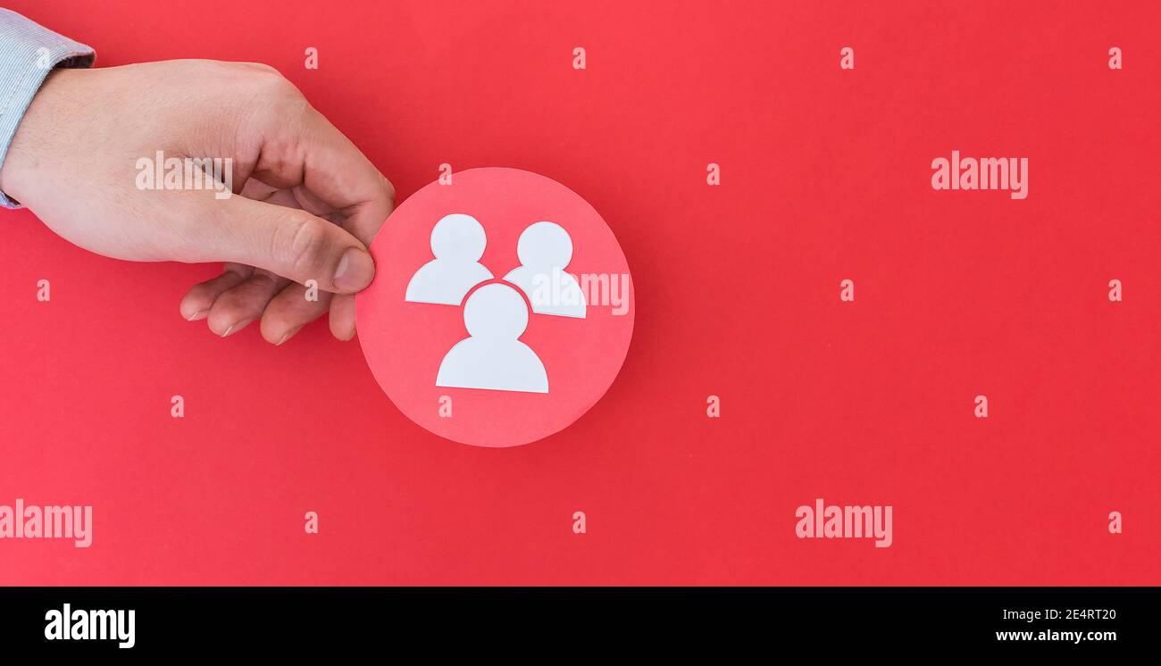 A male hand holding community shape symbol on red background Stock ...