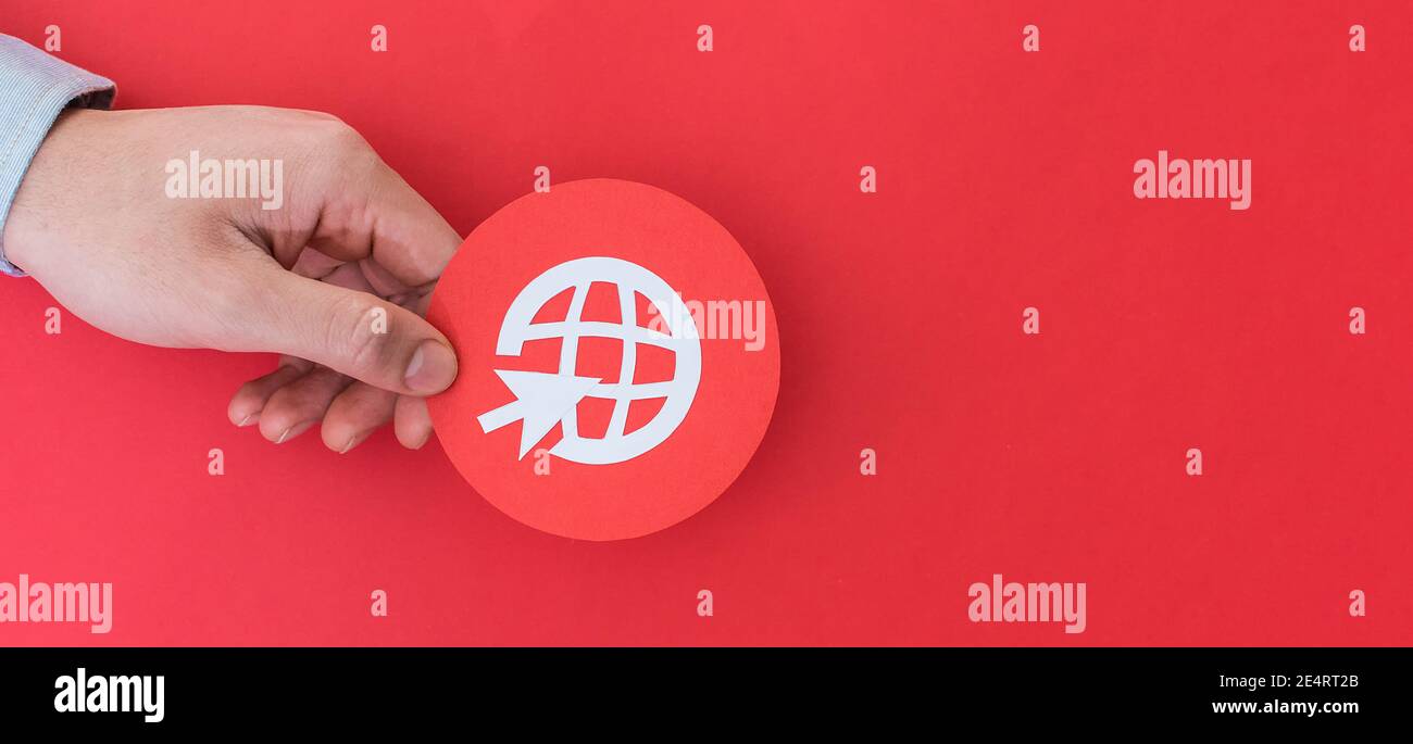 A male hand holding global shape symbol on red background - community ...