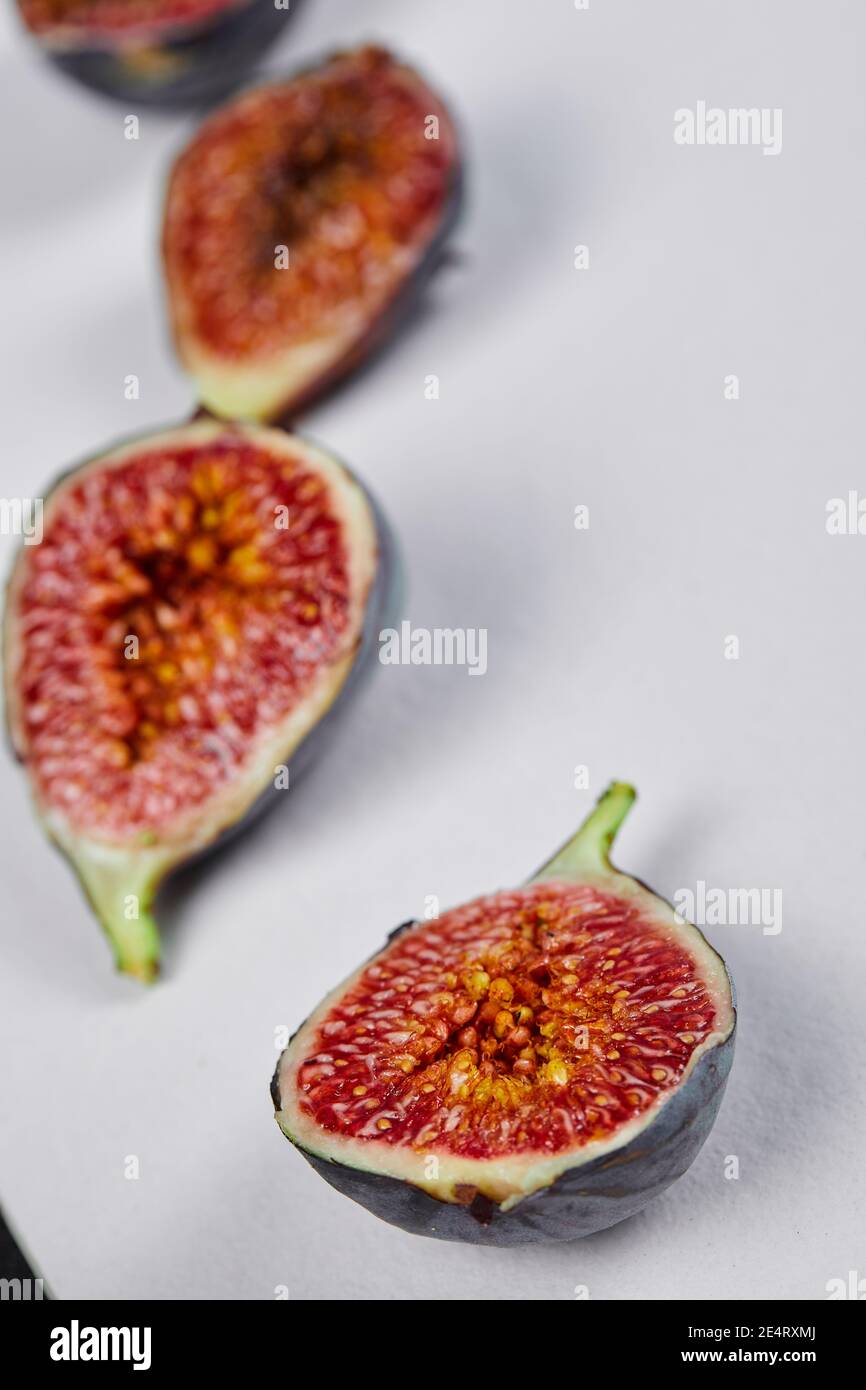 Ripe fig slices on a white background Stock Photo - Alamy