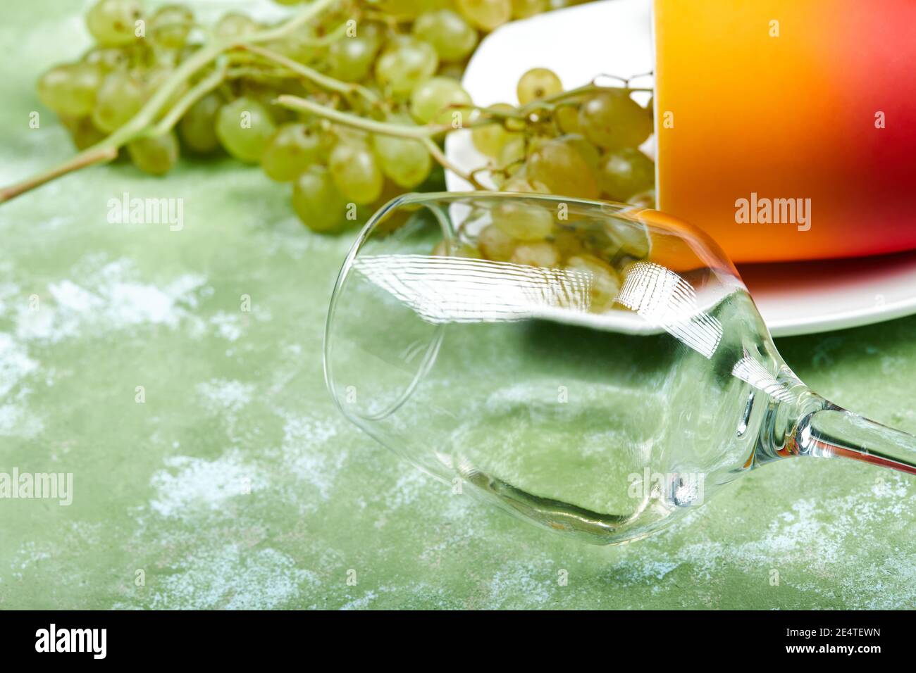 Green grapes with an empty wine glass around Stock Photo - Alamy