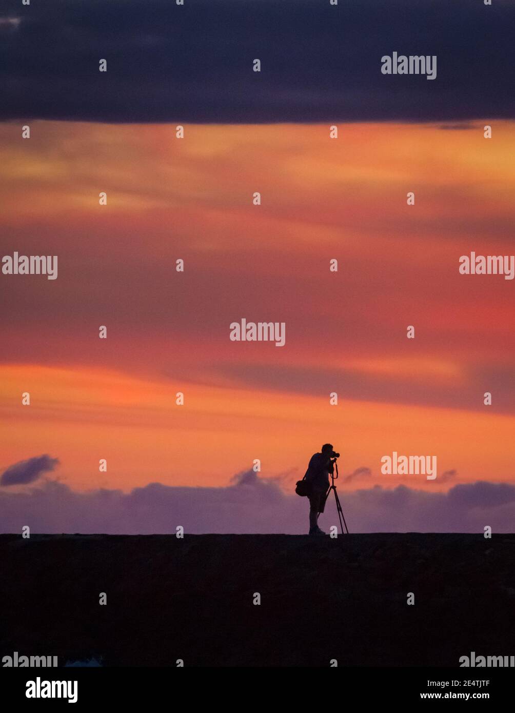 Photographer in the sun rise Stock Photo - Alamy