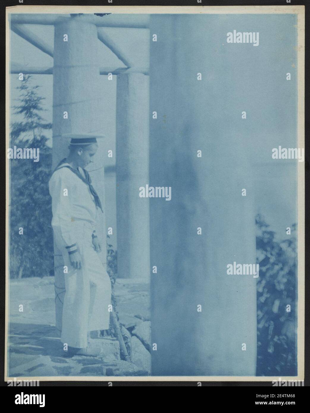 Maynard White in sailor suit standing beside a column on pergola Stock ...