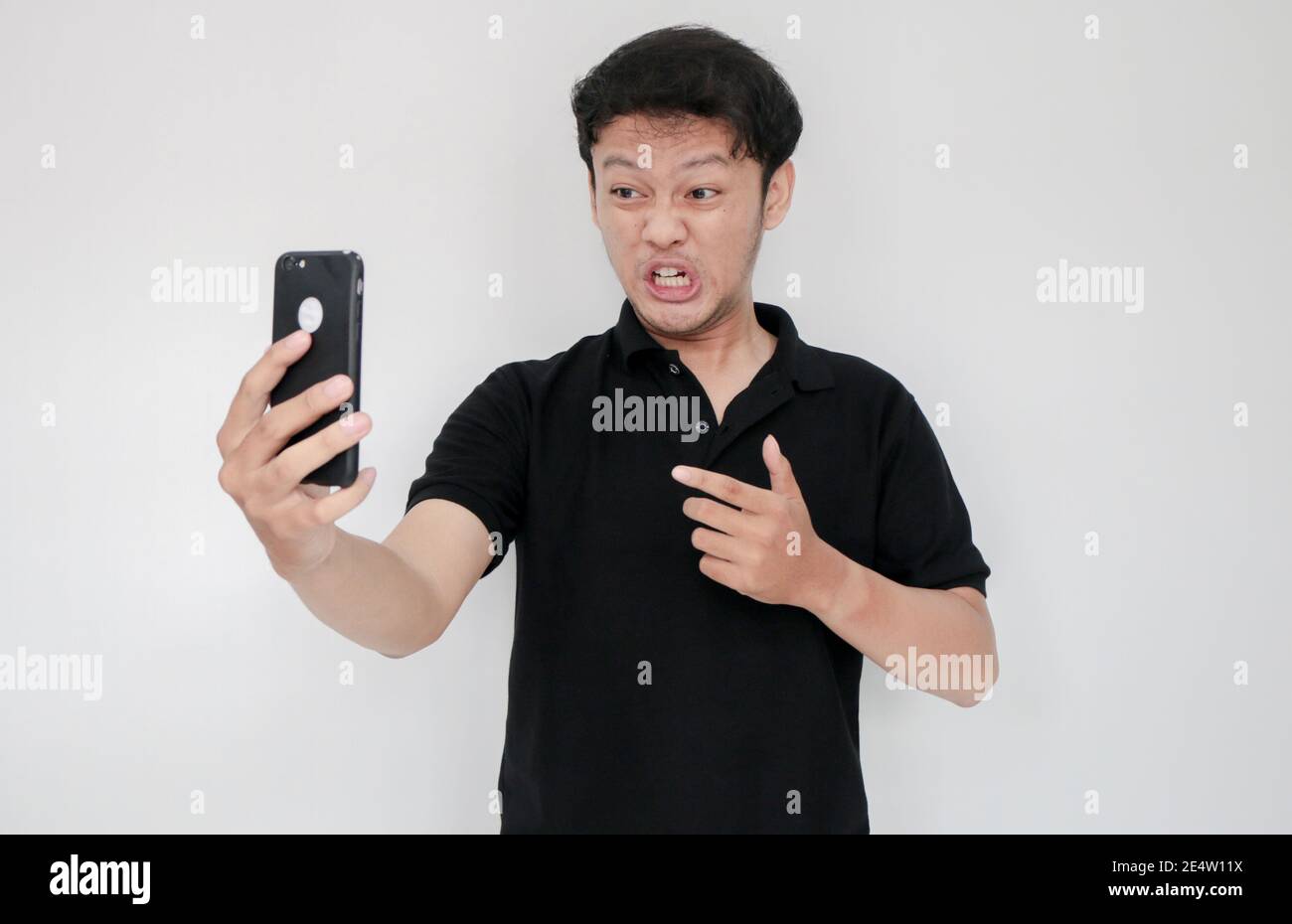 Angry Asian young man get mad on the smartphone. Indonesia Man wear ...