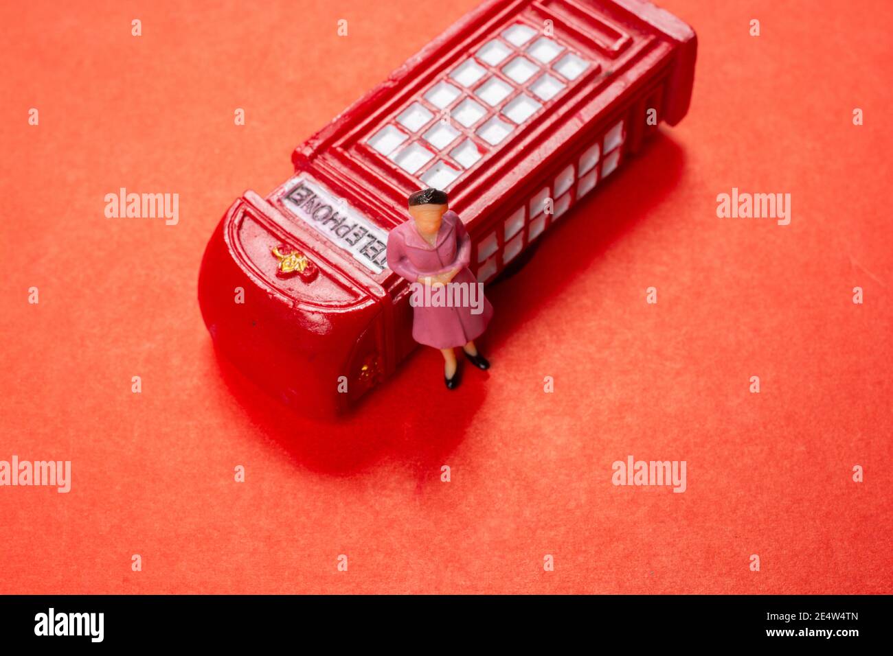 Classical British style Red phone booth model and woman figurine on red ...