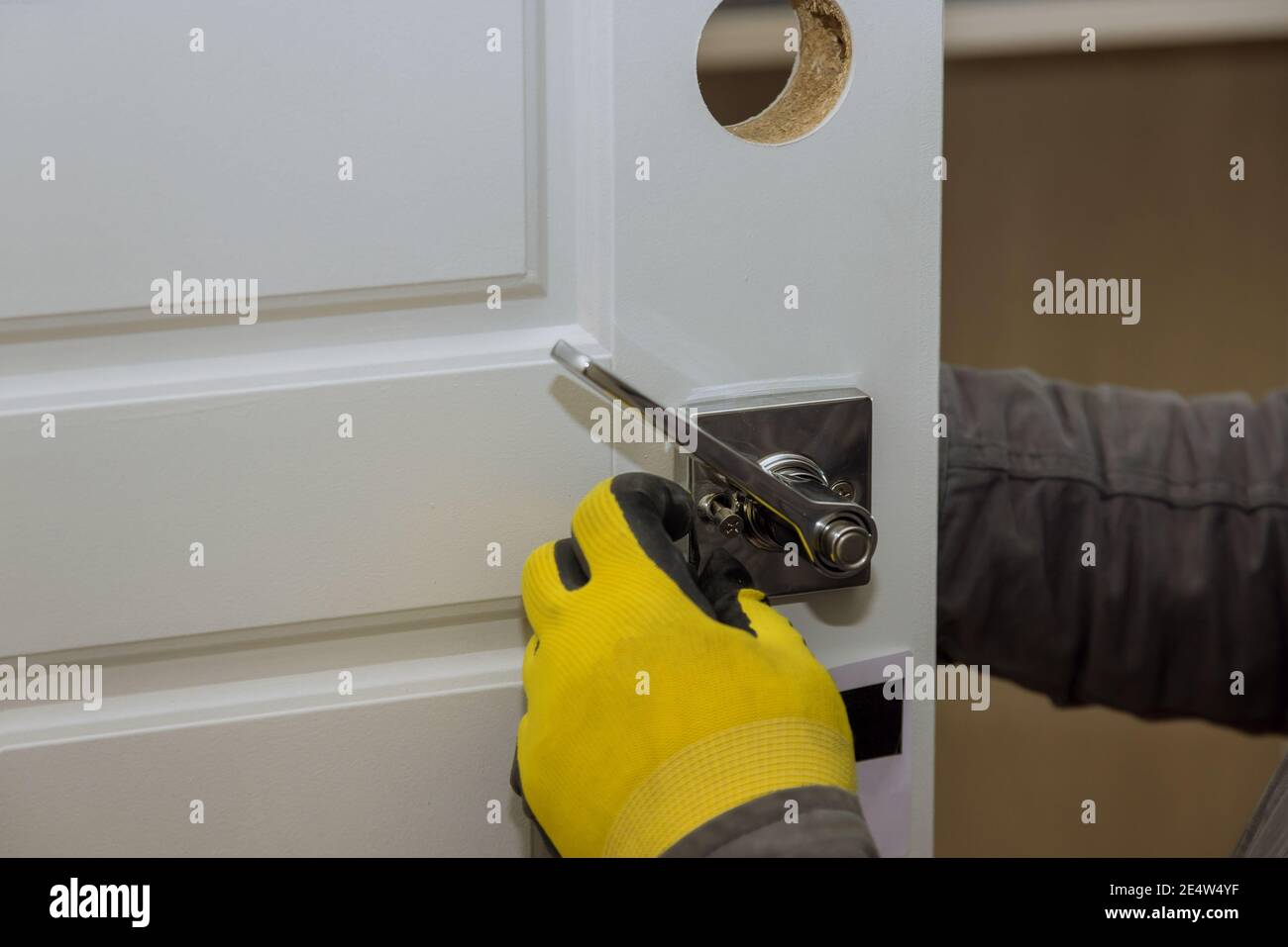 Carpenter installation at interior wood door lock of an apartment Stock ...
