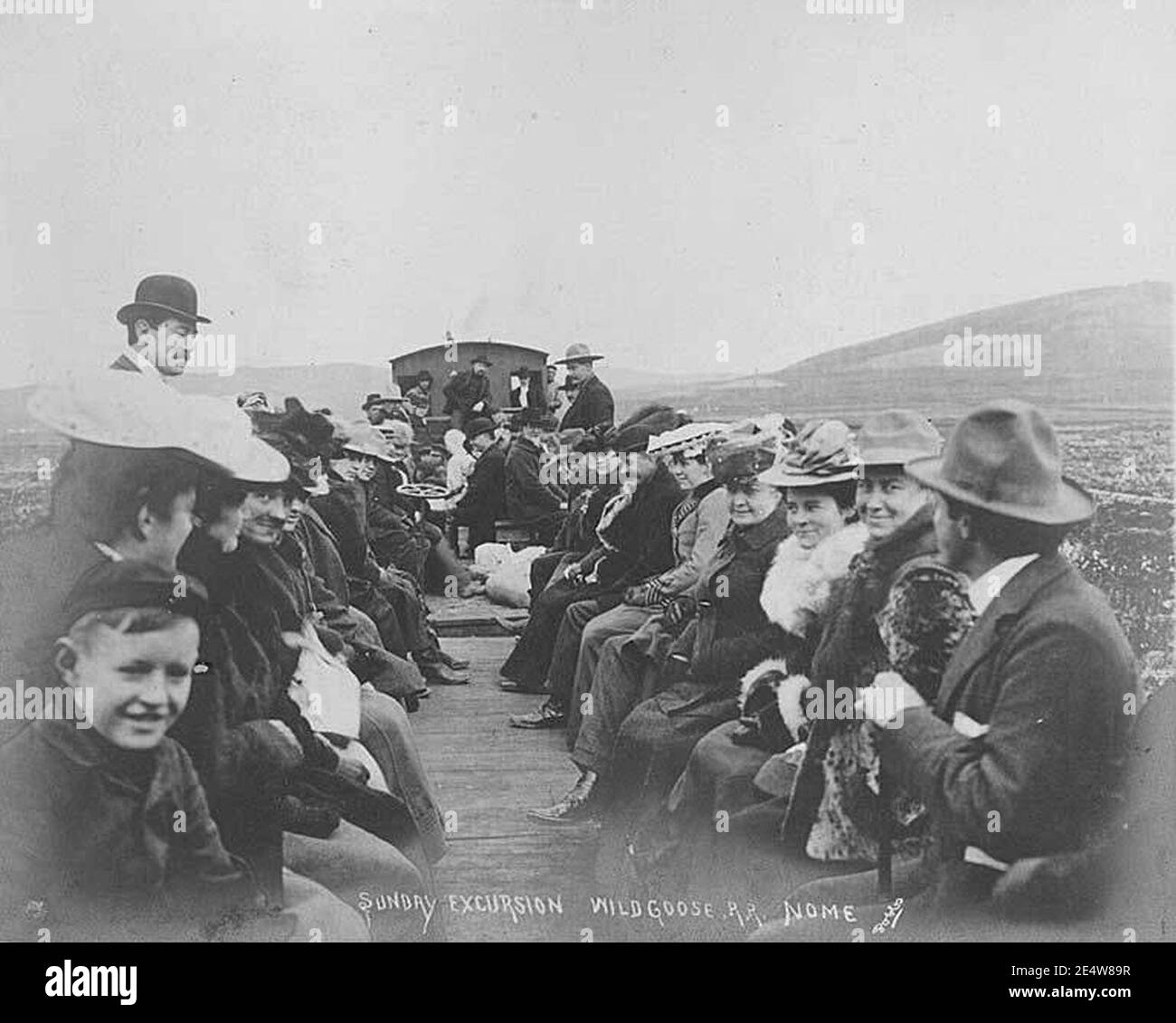 Men, women and children sitting in an open rail car, Wild Goose ...