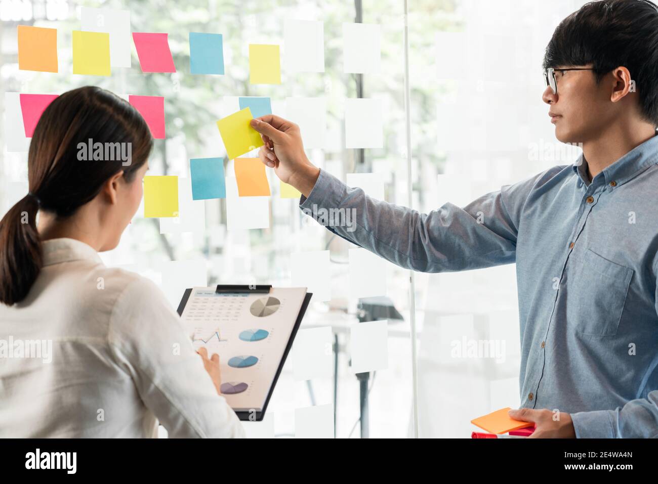 business teamwork in meeting and adhesive stick note on mirror board ...