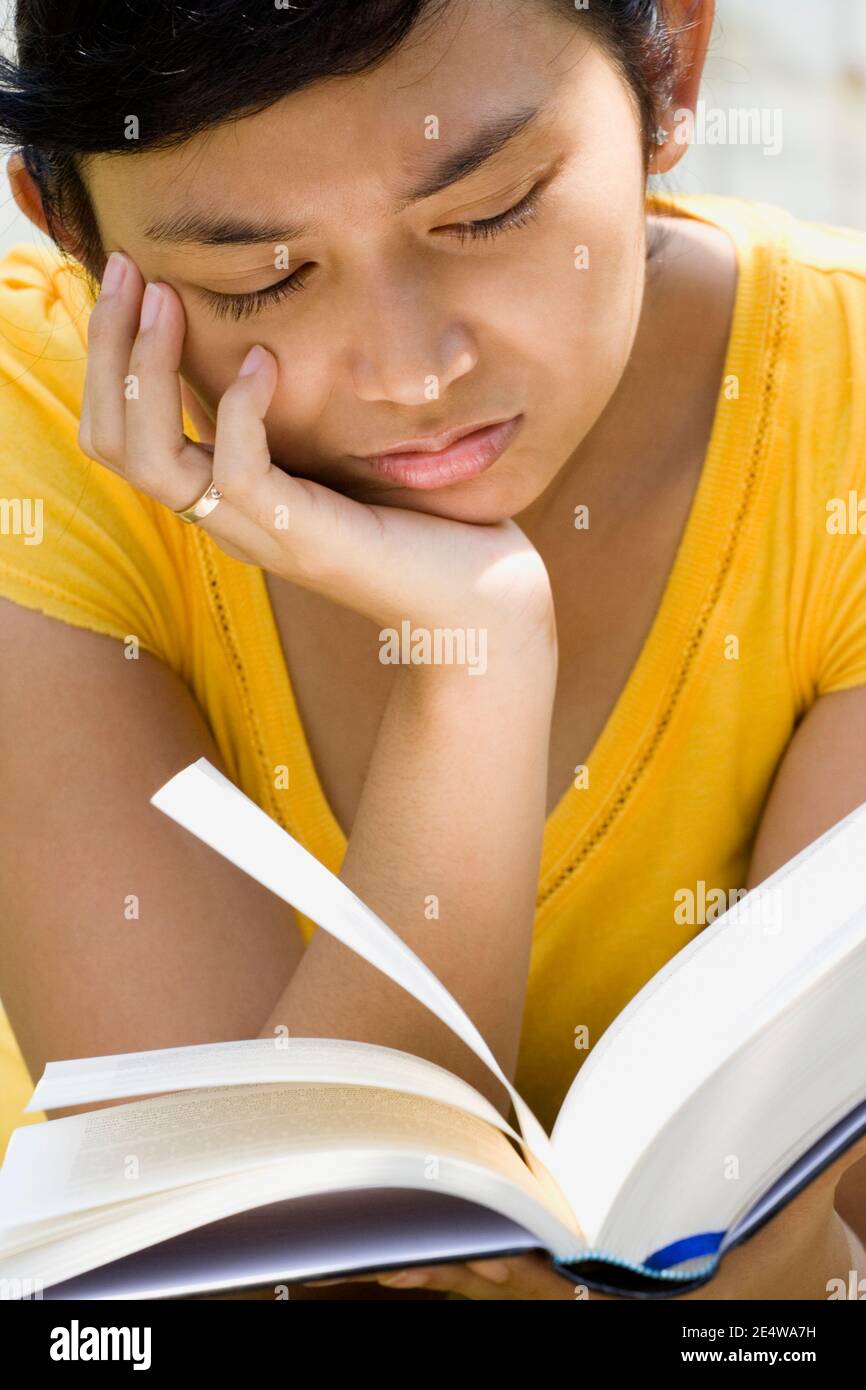 asian young woman feel sad while reading a book outdoor Stock Photo - Alamy