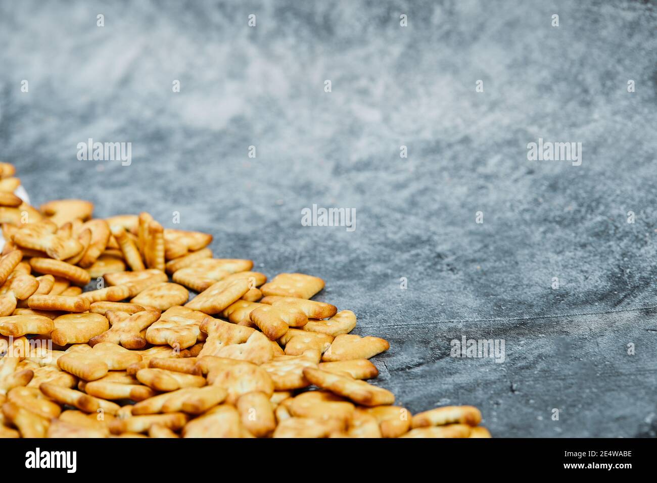 Scattered alphabet crackers on a marble background Stock Photo - Alamy