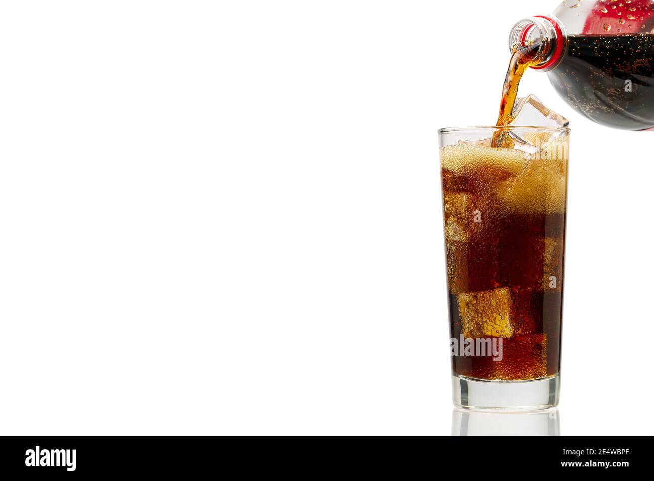 Pouring Cola to glass with ice cubes isolated on white Stock Photo - Alamy