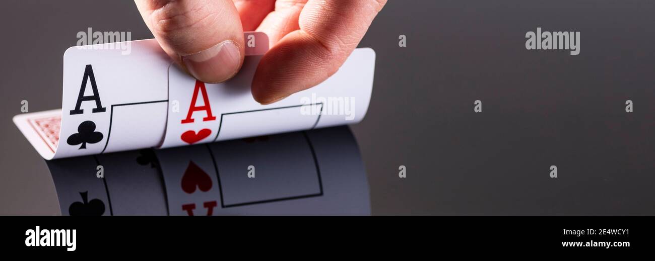a combination of two aces is reflected on the surface of a black ...