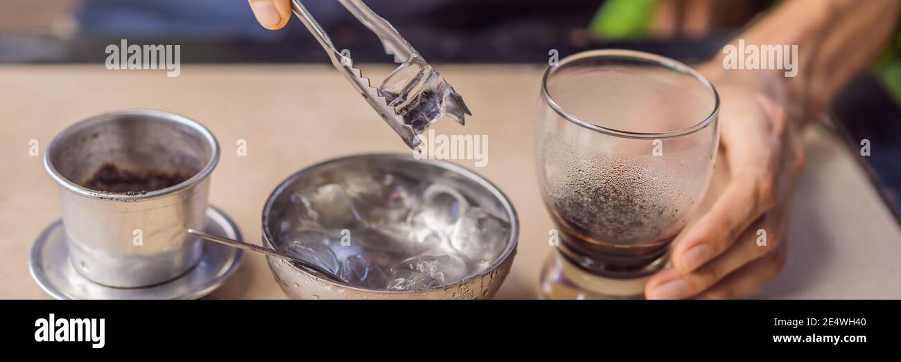 Caucasian man and traditional drip brewed Vietnamese coffee from a phin ...