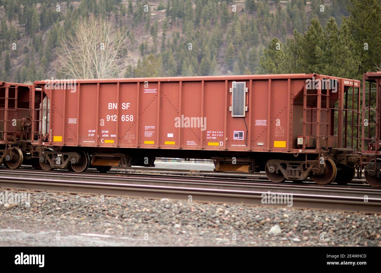 A railroad hopper car on the tracks at the BNSF train yard, in the town ...