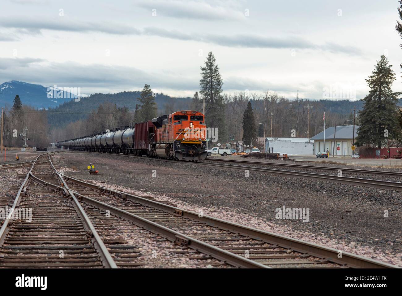 The tailing push locomotive of a BNSF oil tanker frieght train coming ...