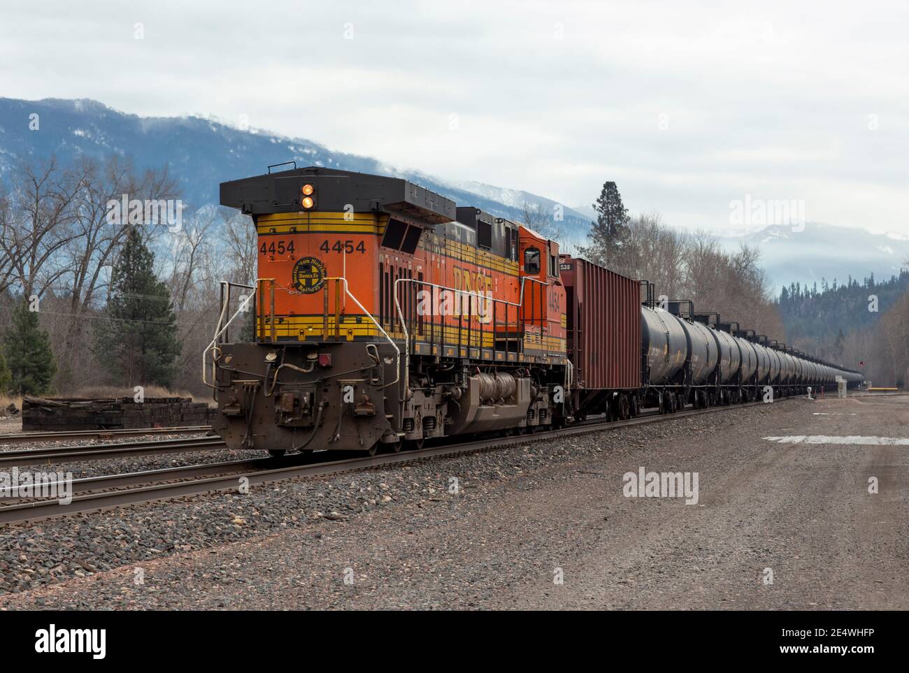 The tailing push locomotive of a BNSF oil tanker frieght train coming ...