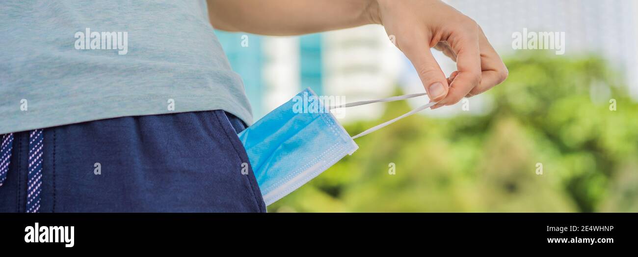 Improper wearing of mask concept. Woman wants to wear an old, crumpled ...