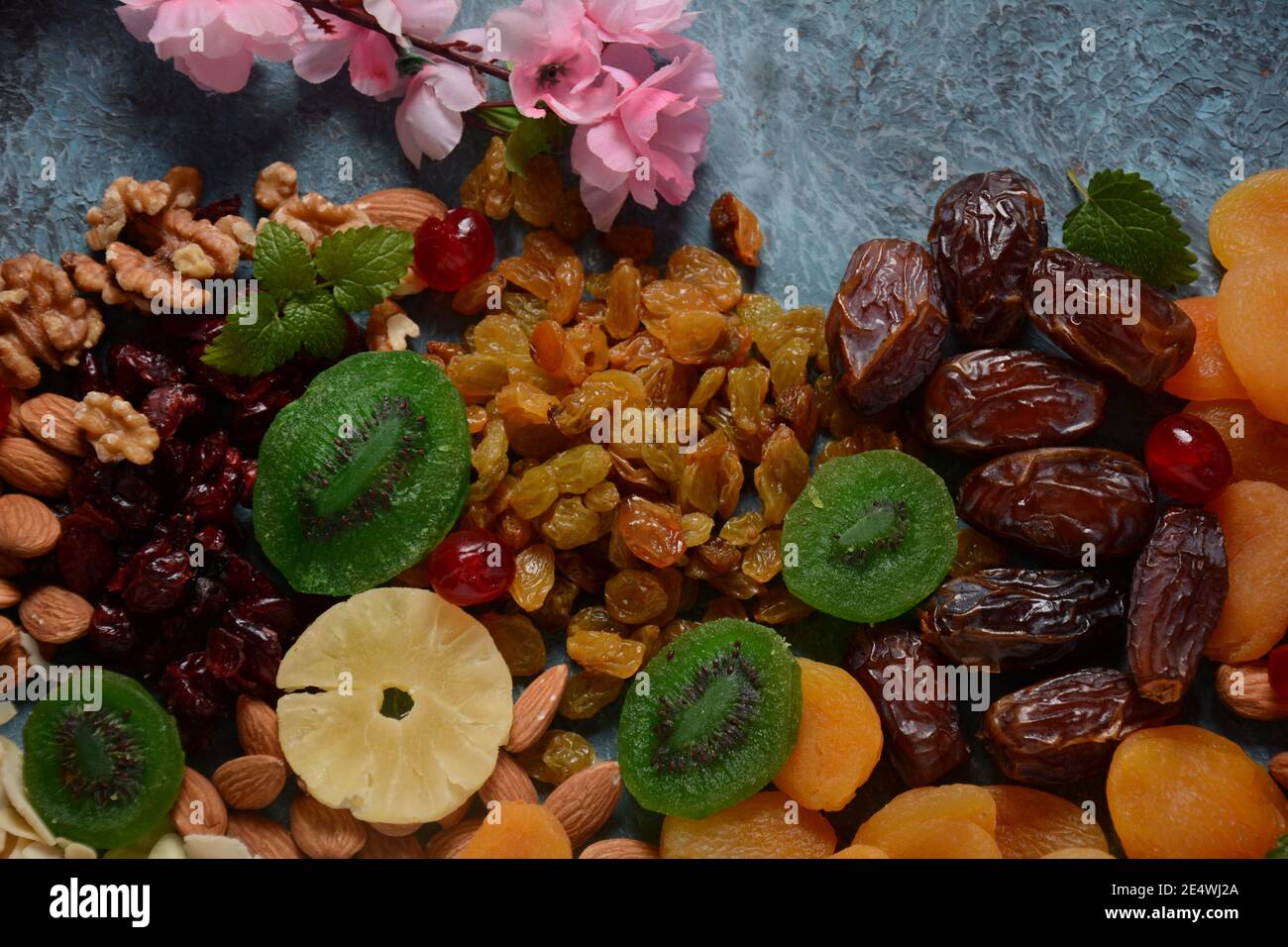 Mix of dried and sun-dried fruits, and nuts. Kiwi, apricot. Symbols of ...