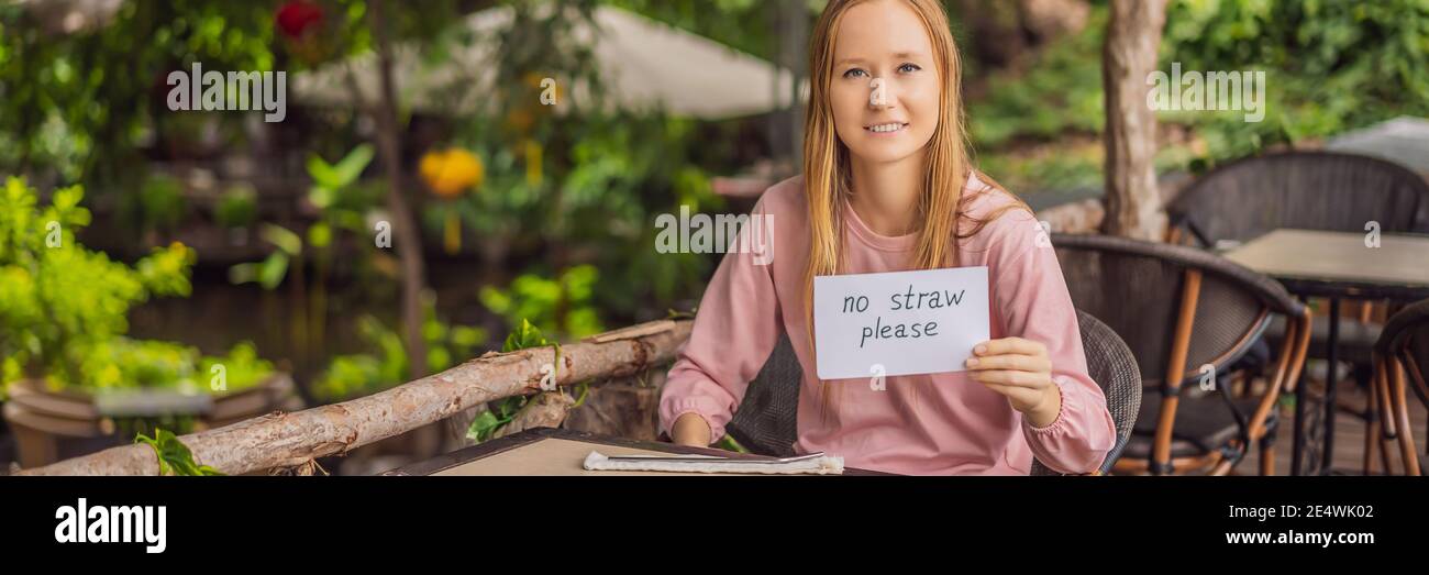 Young woman in a cafe shows a sign - no straws please. No plastic ...