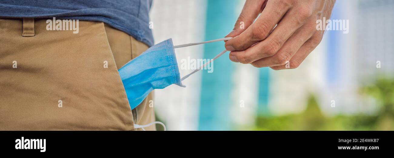 Improper wearing of mask concept. Man wants to wear an old, crumpled ...